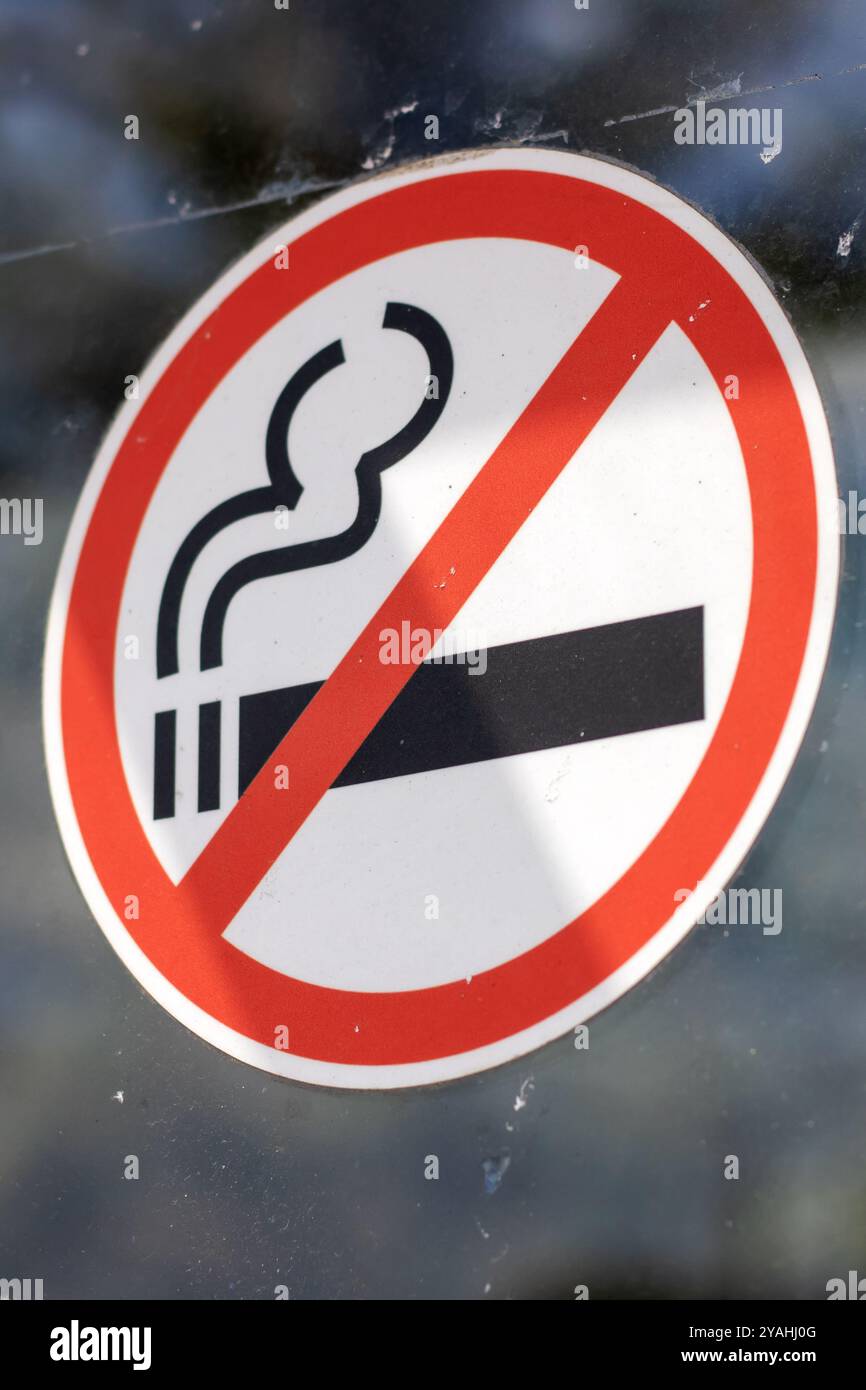 A no smoking sign on glass promotes smokefree areas, raising public ...