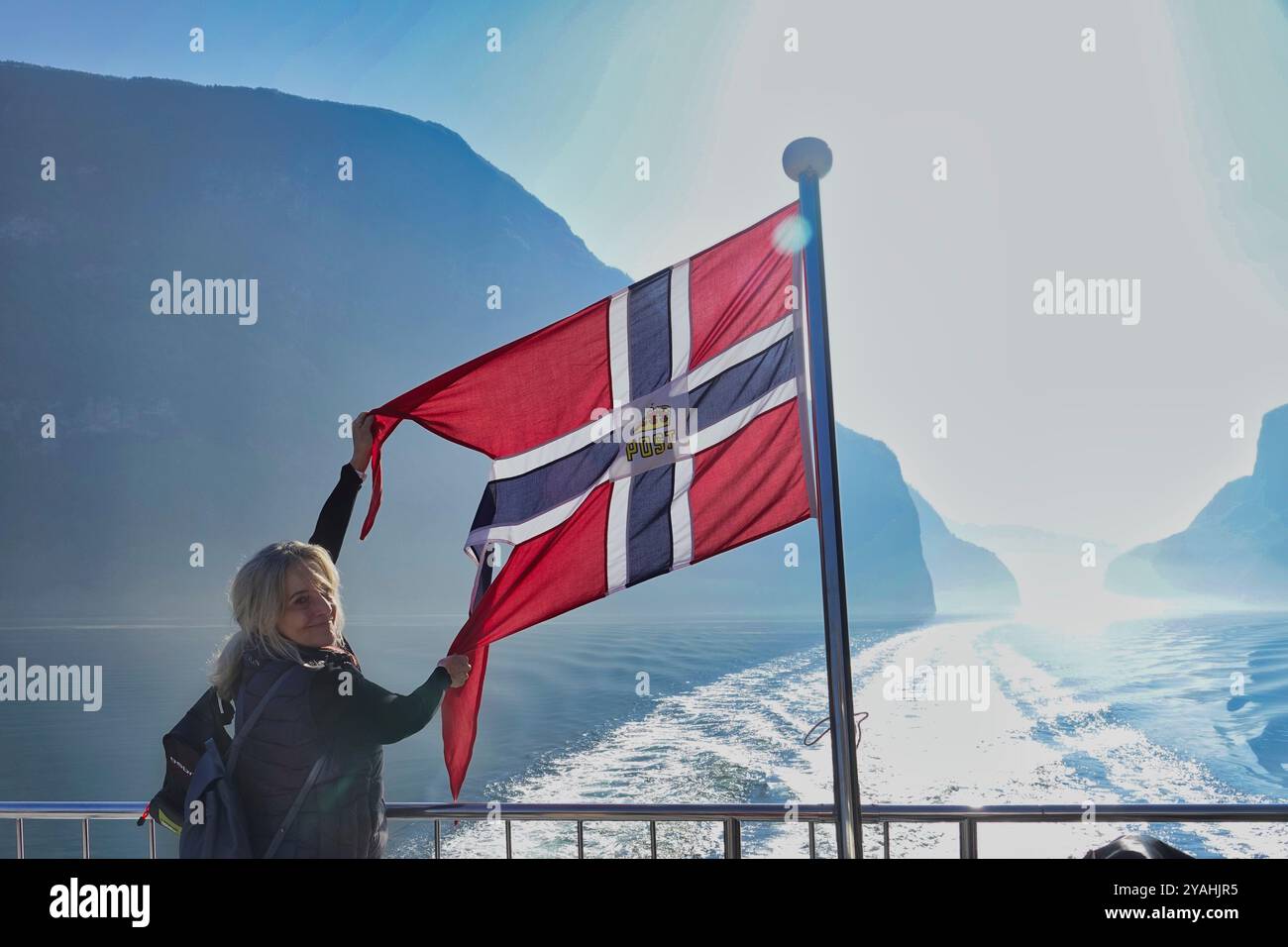 7th September, 2024 Flam , Norway Female tourist displays the Norwegian ...