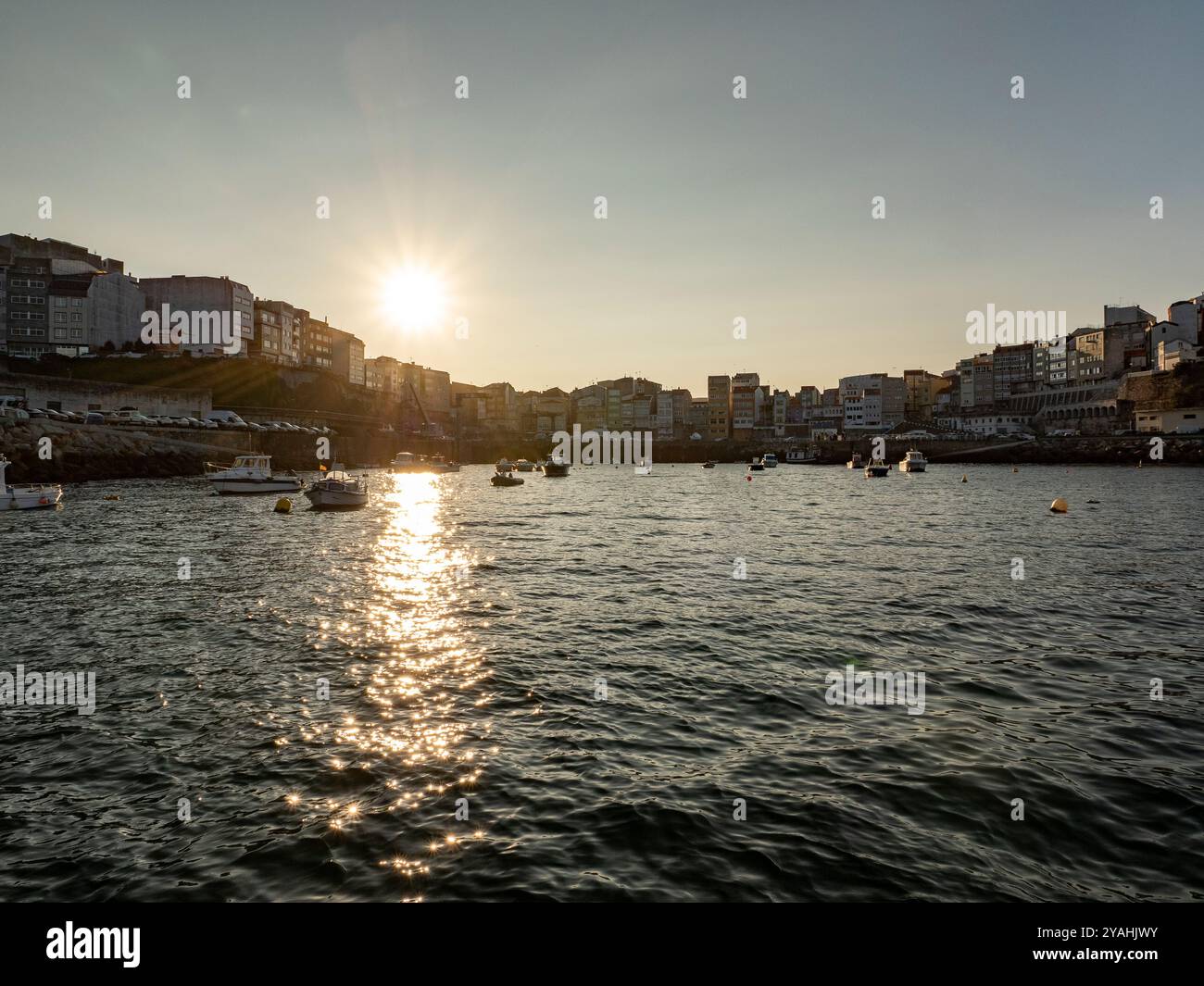 Sunset over the Spanish fishing village Fisterra in Galicia Stock Photo ...