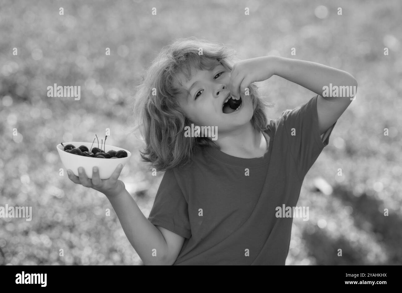 The child eats cherries. Excited face. Cherry for kids. Teenager child ...