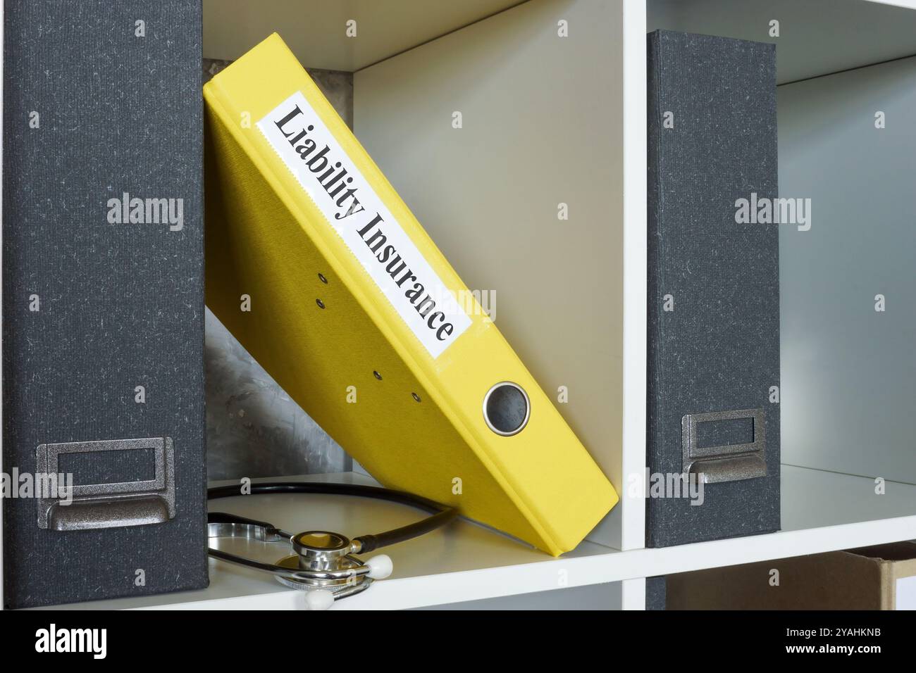 A medical stethoscope next to a folder labeled liability insurance ...
