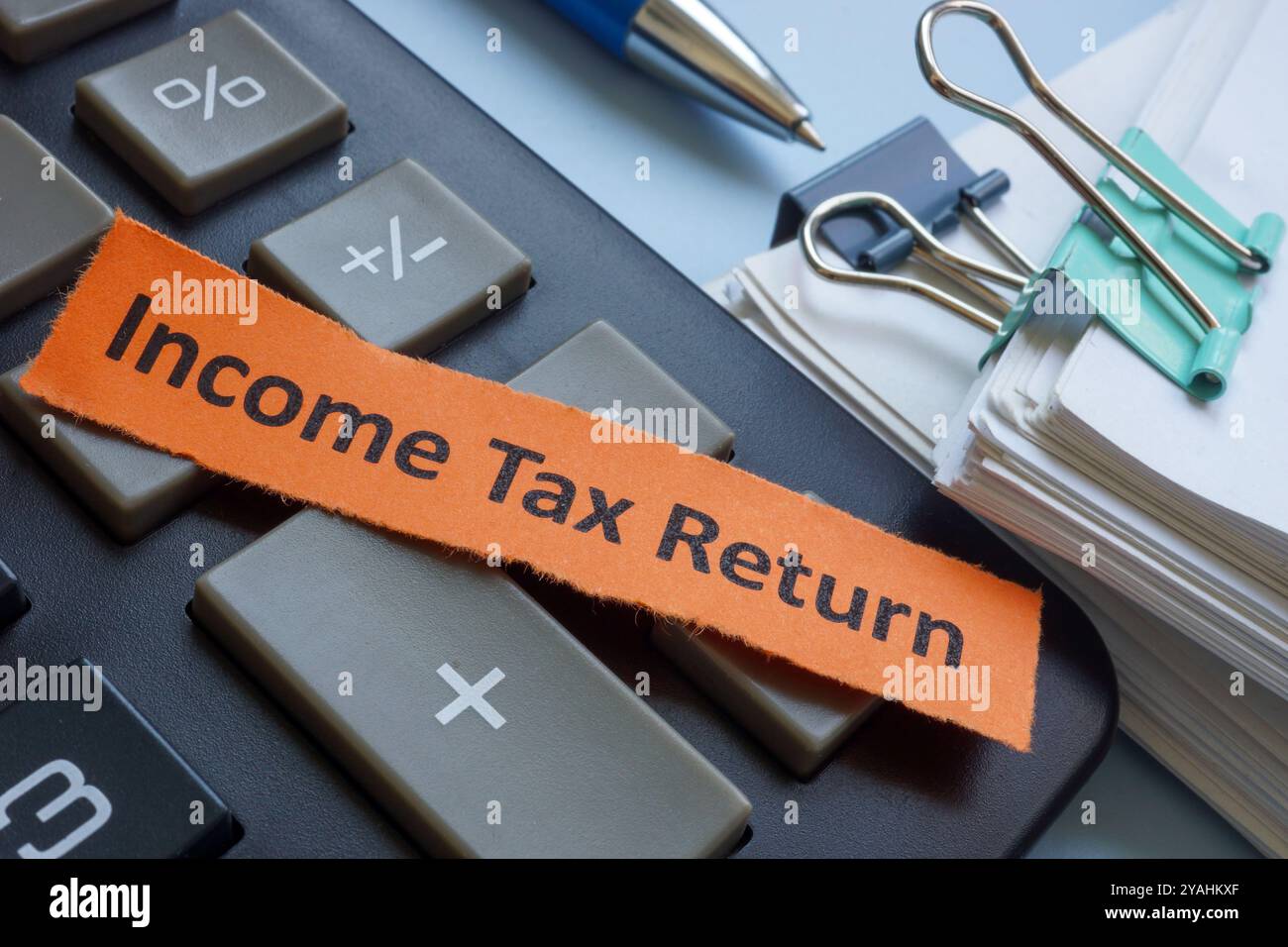 Income tax return with a label, calculator and papers Stock Photo - Alamy