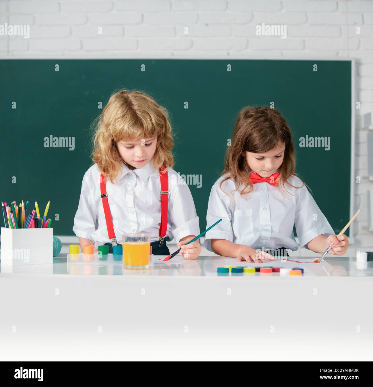 Cute friends kids drawing and painting at school. Friendly boy an girl ...