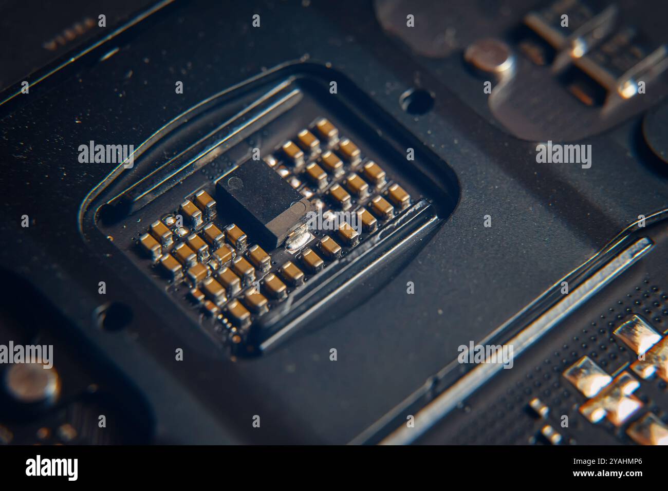 Closeup of a microchip on a detailed circuit board showing its ...