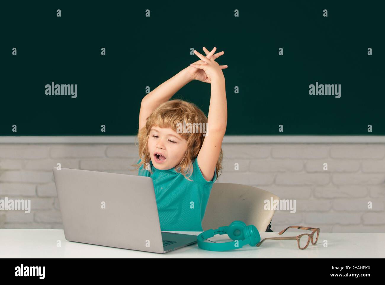 Tired sleepy child using gadgets to study. Computer hard education for ...