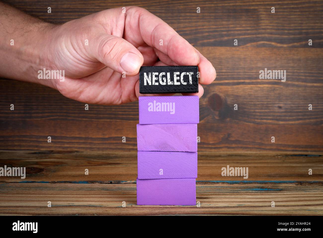 NEGLECT. Purple blocks on wood texture background Stock Photo - Alamy