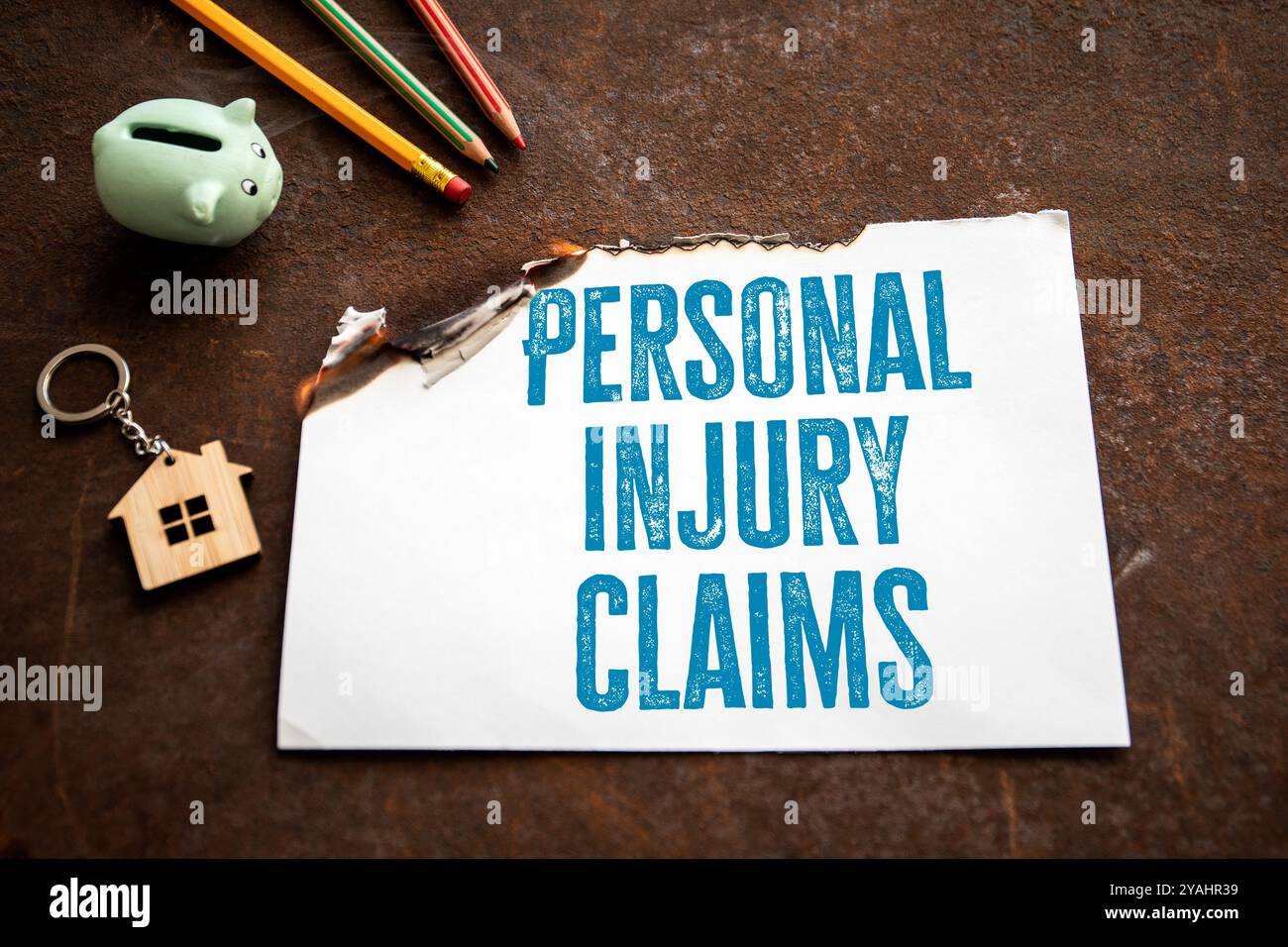 Personal Injury Claims. Burning paper with text on rusting metal ...