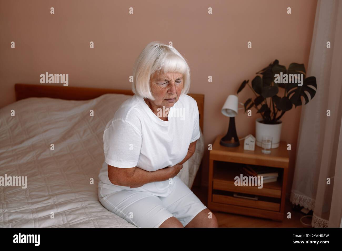 Abdominal pain in elder senior mature aging woman with stomachache ...