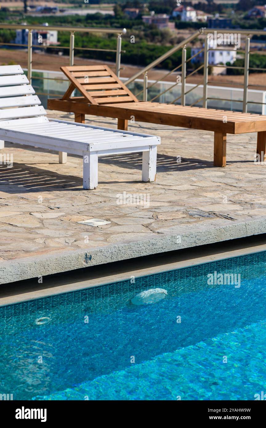 pool in resort, terrace with sofas and sun loungers by the pool Stock ...