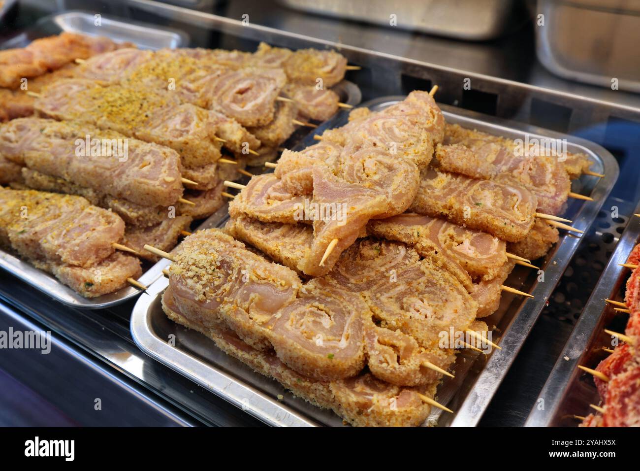 Street food in Syracuse city in Sicily, Italy. Raw chicken on stick ...