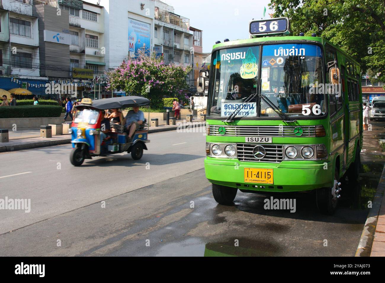 BANGKOK, THAILAND - MARCH 30, 2008: Tuk tuk taxi and public transportation bus in Bangkok city ...