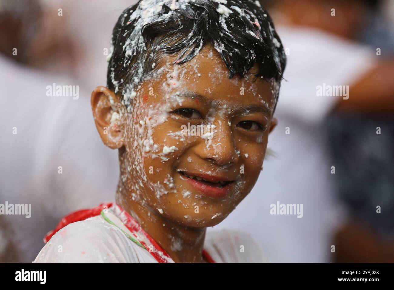 Sindhupalchok, Nepal. 14th Oct, 2024. A participant covered in curd ...