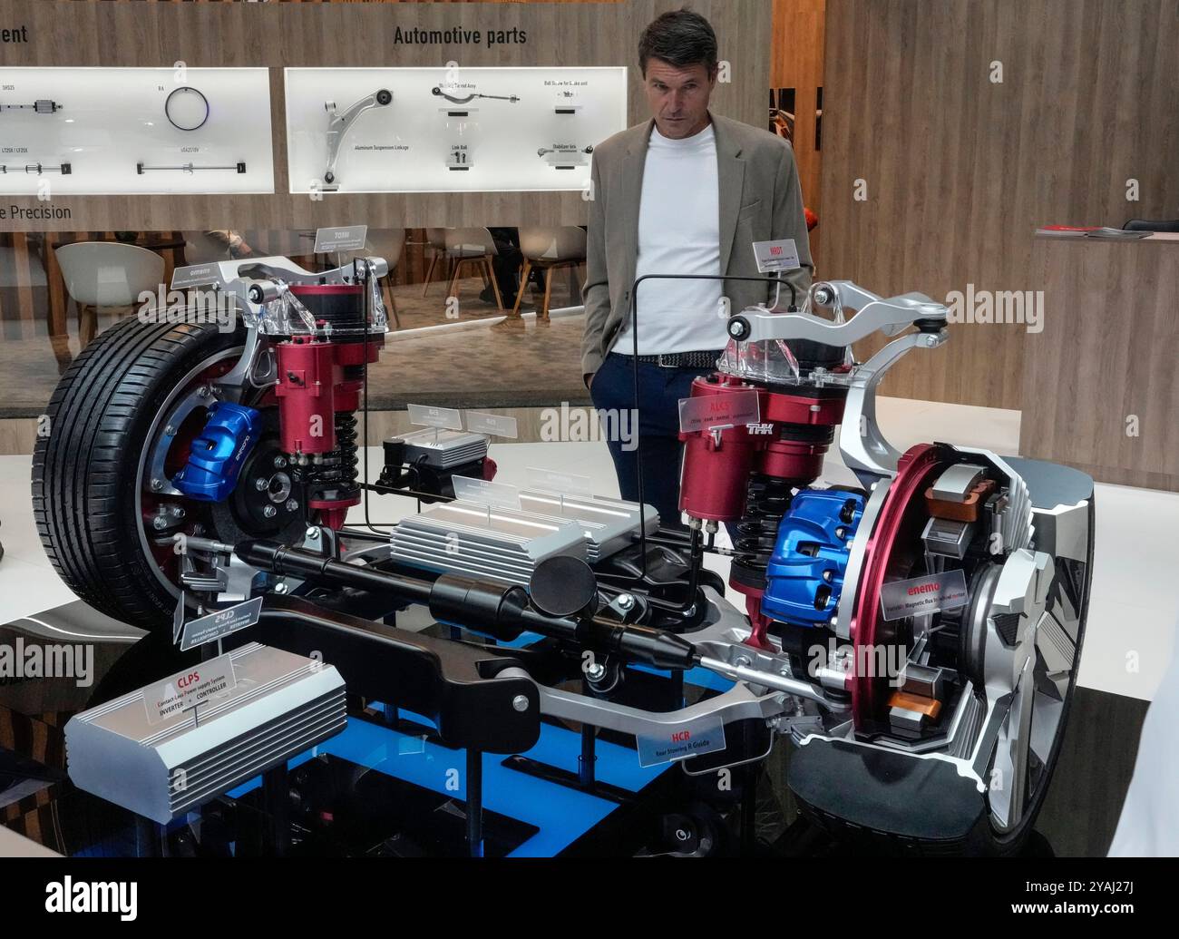 A man looks at the engine of a THK LSR-05 electric prototype at the Paris Auto Show, in Paris ...