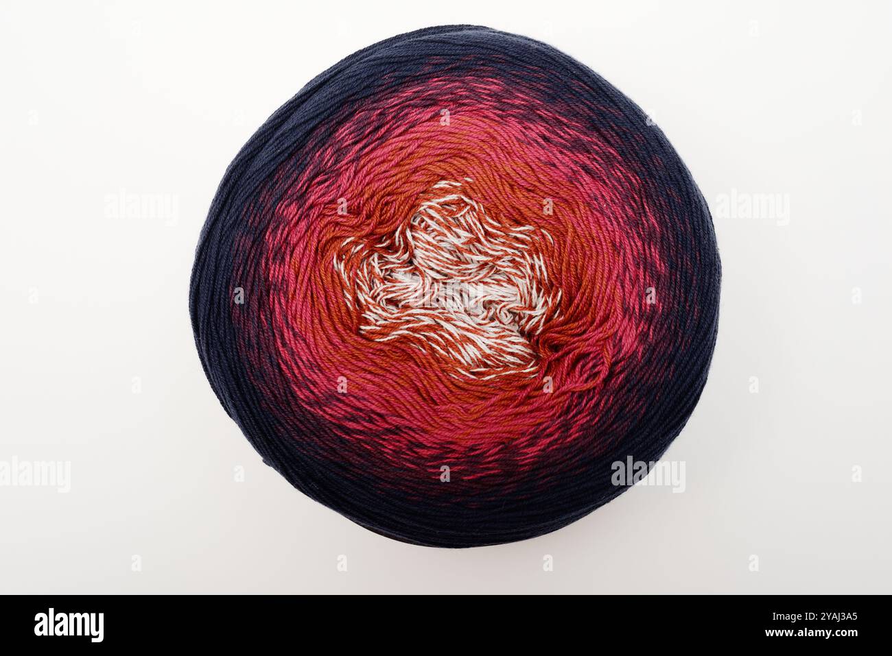 This image shows a skein of yarn with a gradient color transition from ...