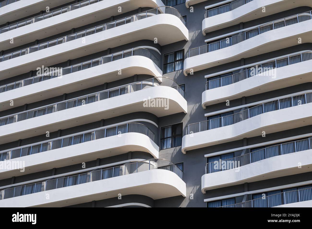 Facade of a modern skyscraper apartment building with large balconies ...
