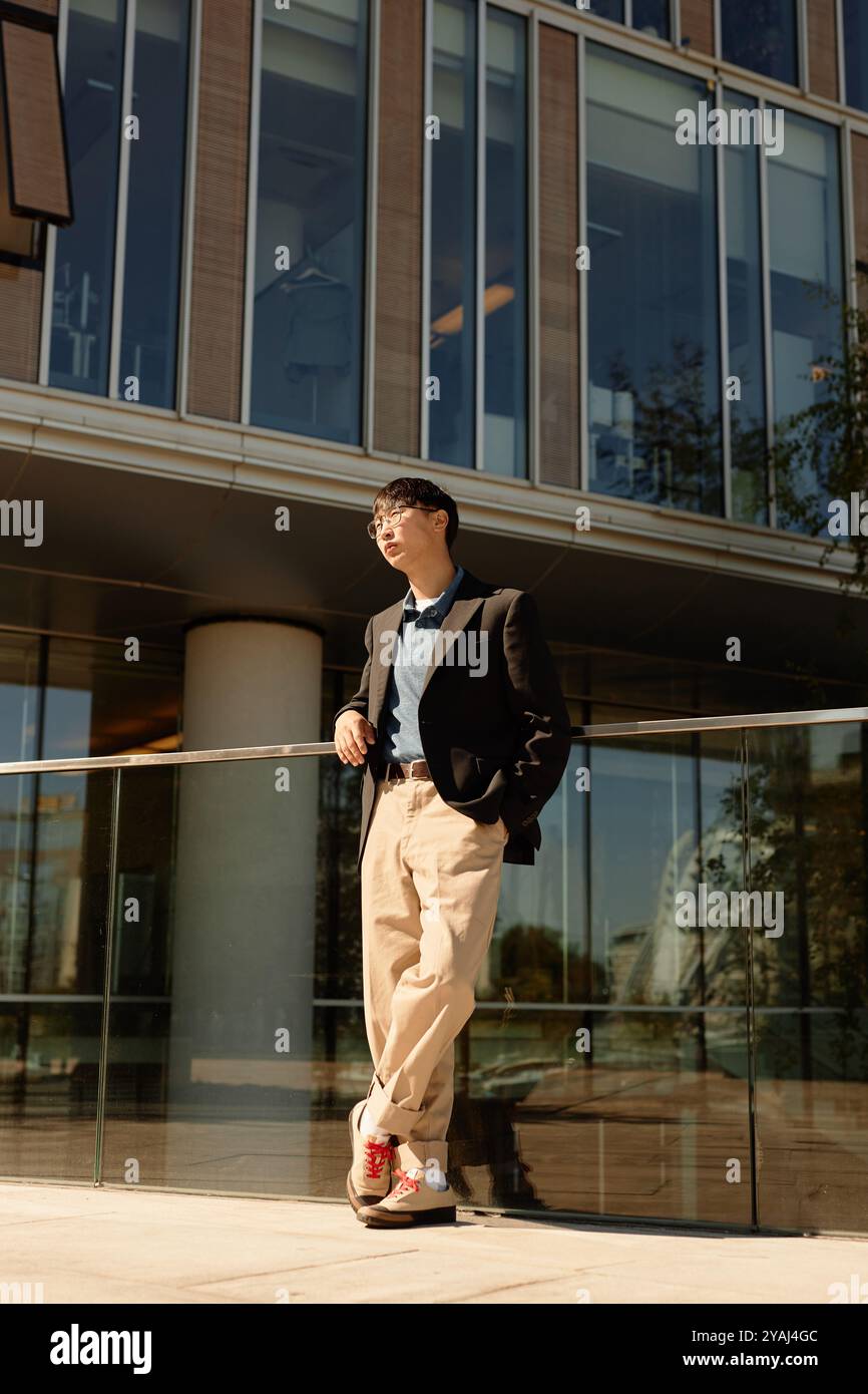 Vertical shot of Asian male corporate worker wearing stylish outfit for ...