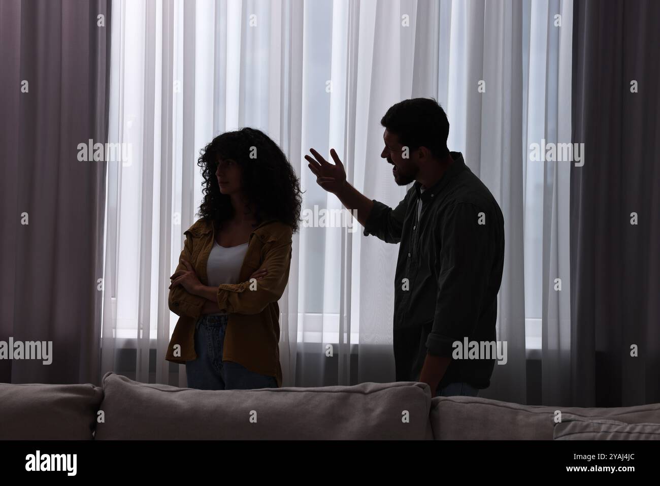 Emotional couple having quarrel indoors at night. Relationship problems ...