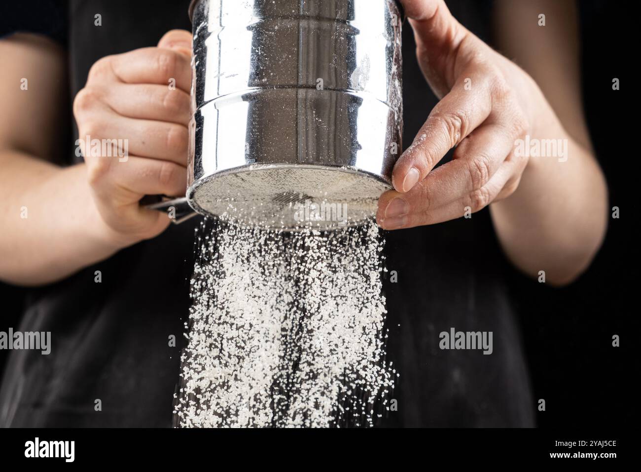 Woman sifting flour through sieve hi-res stock photography and images ...