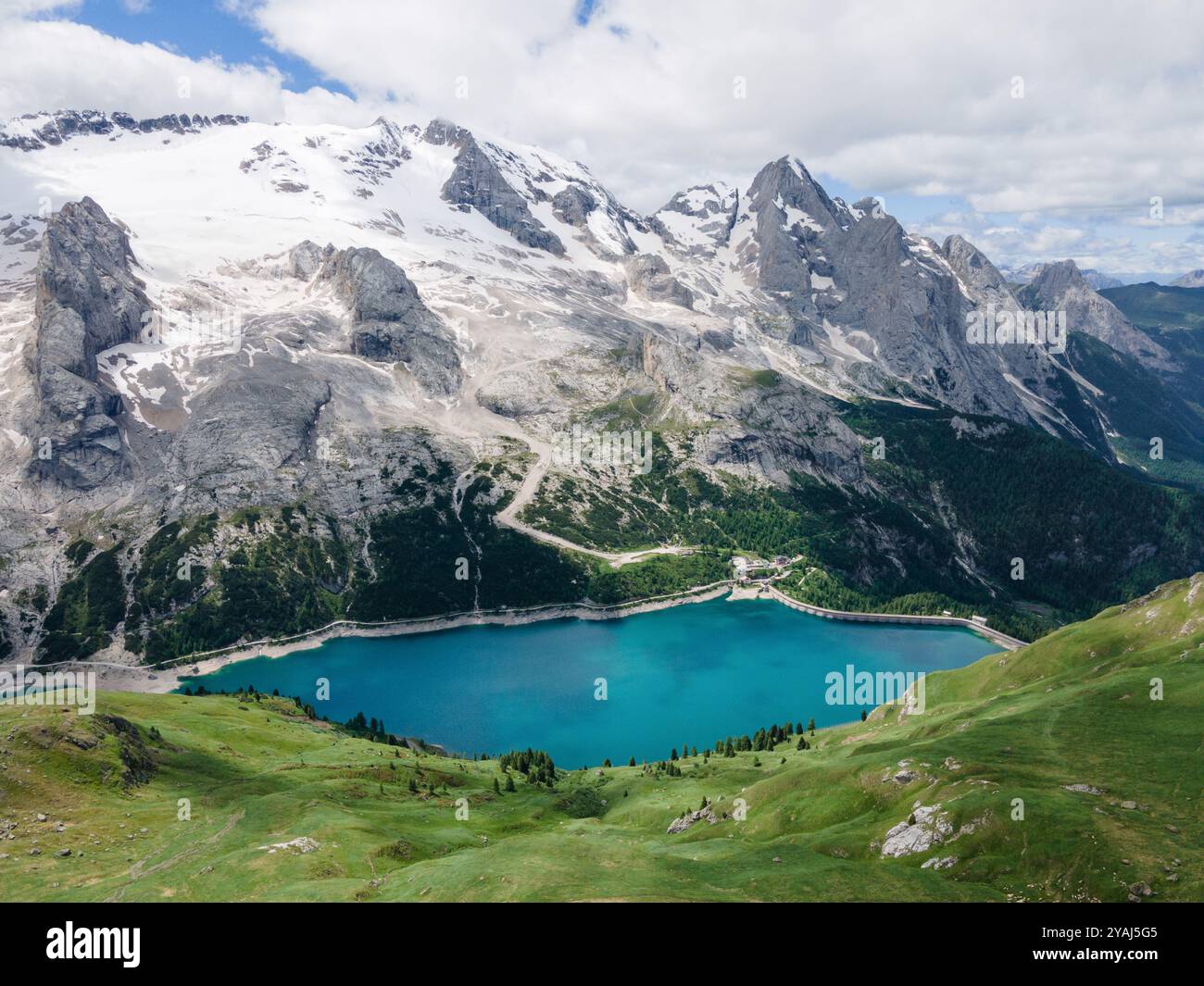 Fedaia lake and dam, Marmolada massif group background with glacier ...