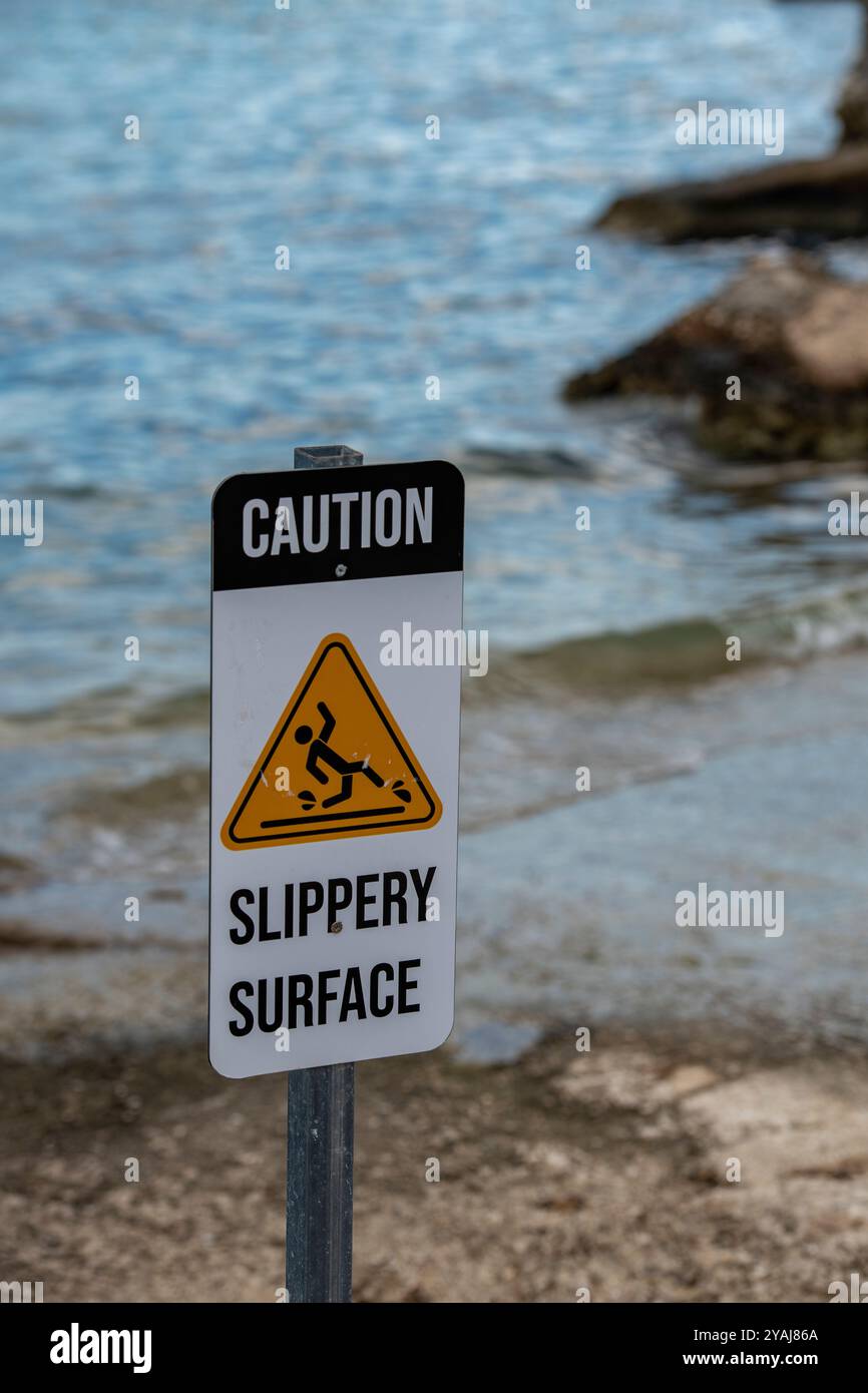 caution, slippery surface warning sign Stock Photo - Alamy