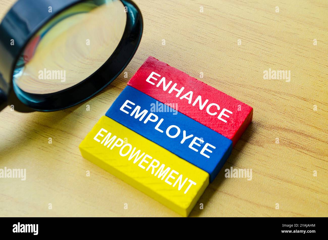 Top view of Enhance Employee Empowerment text on multicolored wooden ...