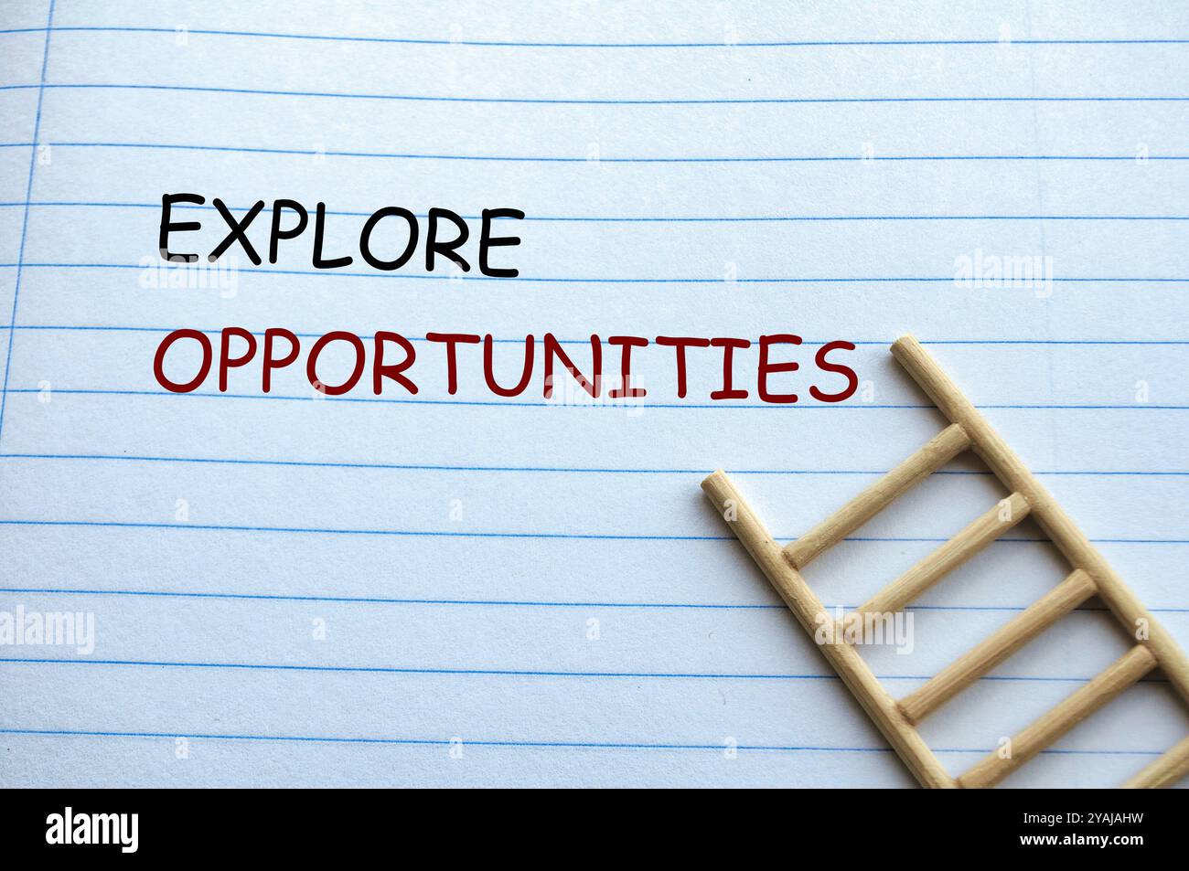 Explore Opportunities text on notebook with wooden ladder background ...