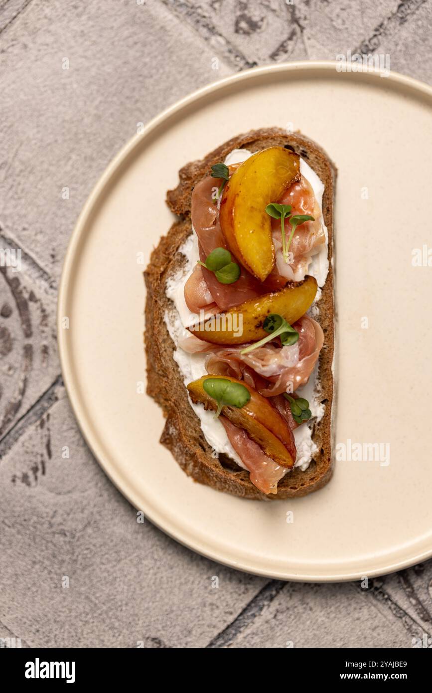Sandwich with cream cheese, prosciutto and peach Stock Photo - Alamy