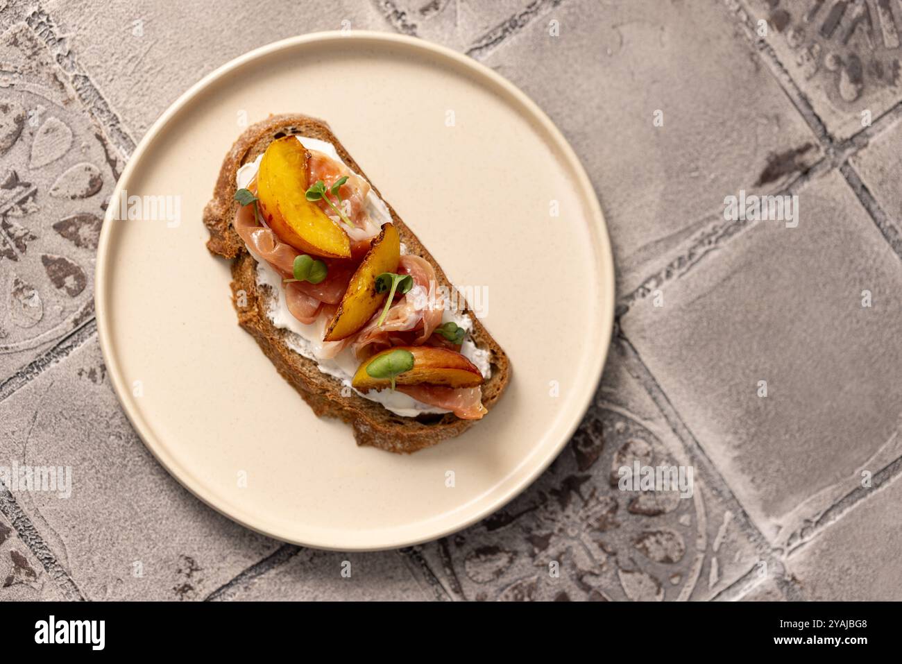 Sandwich with cream cheese, prosciutto and peach Stock Photo - Alamy