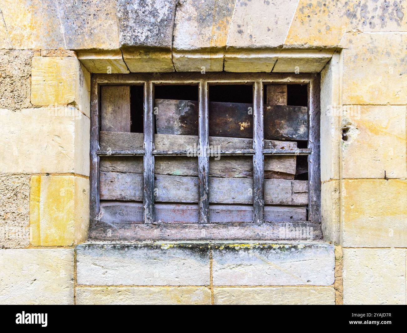 Blocked broken window in stone wall of old building - Le Petit ...