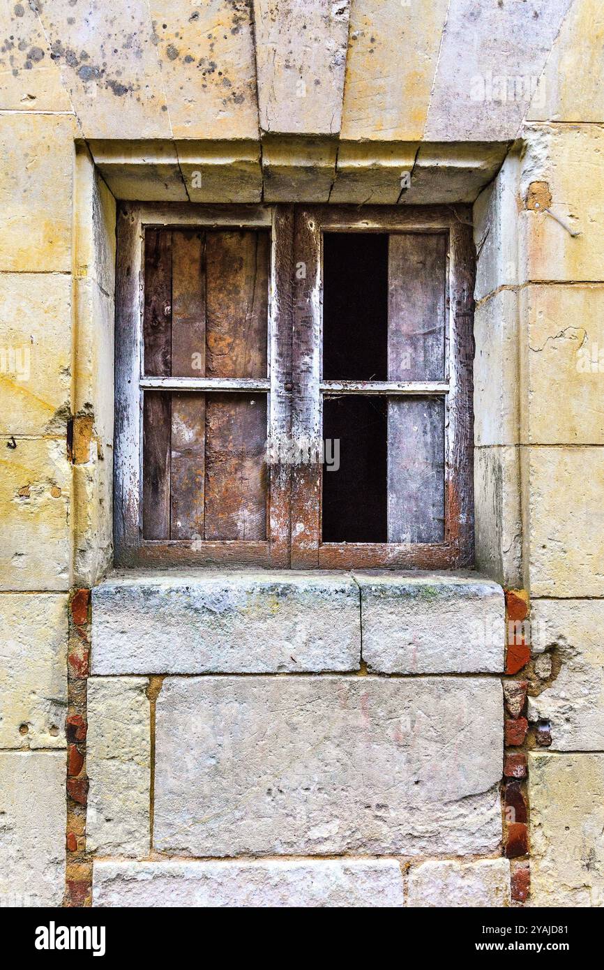 Blocked broken window in stone wall of old building - Le Petit ...