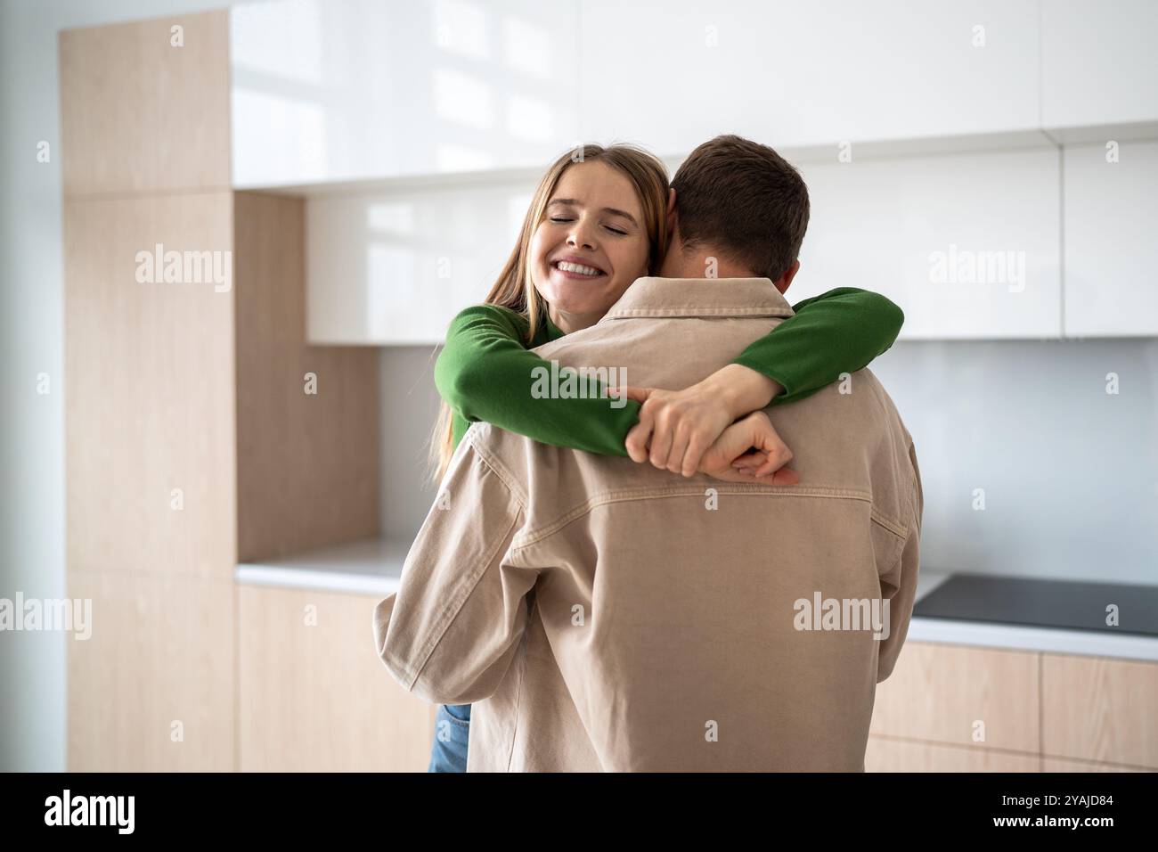 Happy overjoyed woman hugging husband with closed eyes, feeling love ...