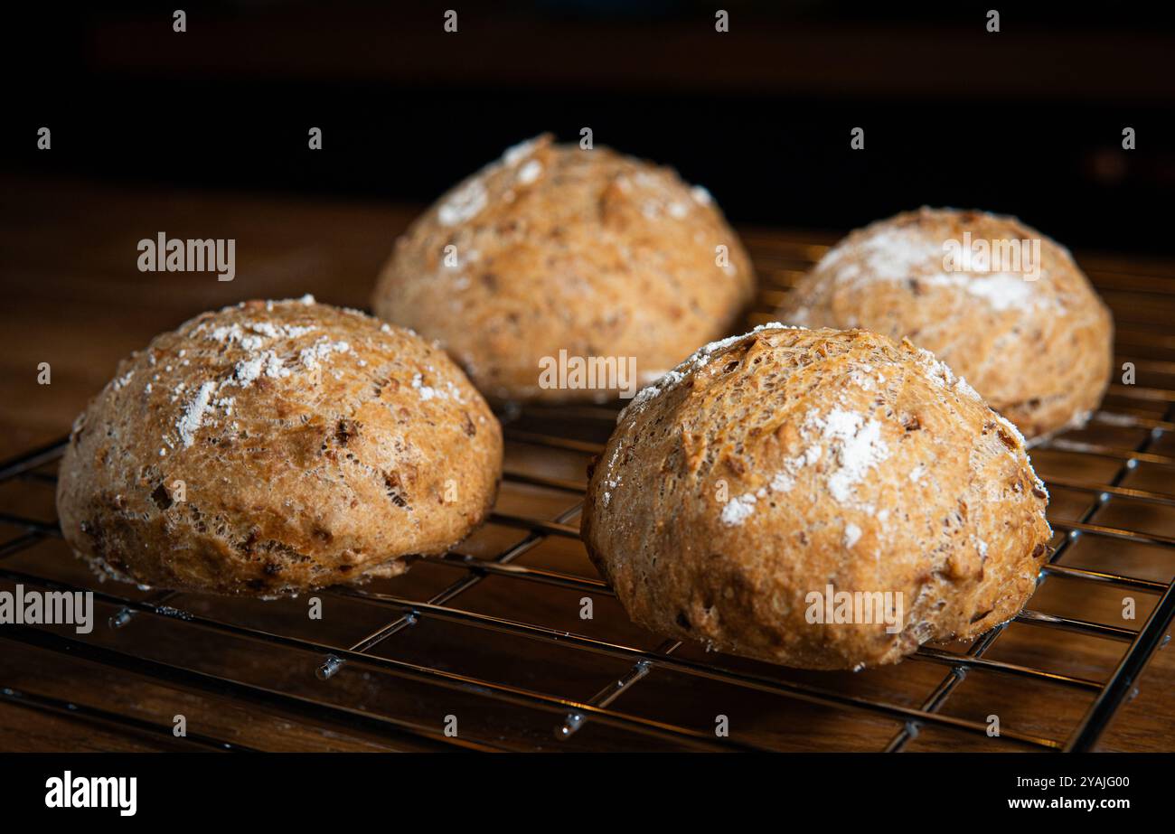 Four classic farm country bread buns on a grill. These homemade rustic ...
