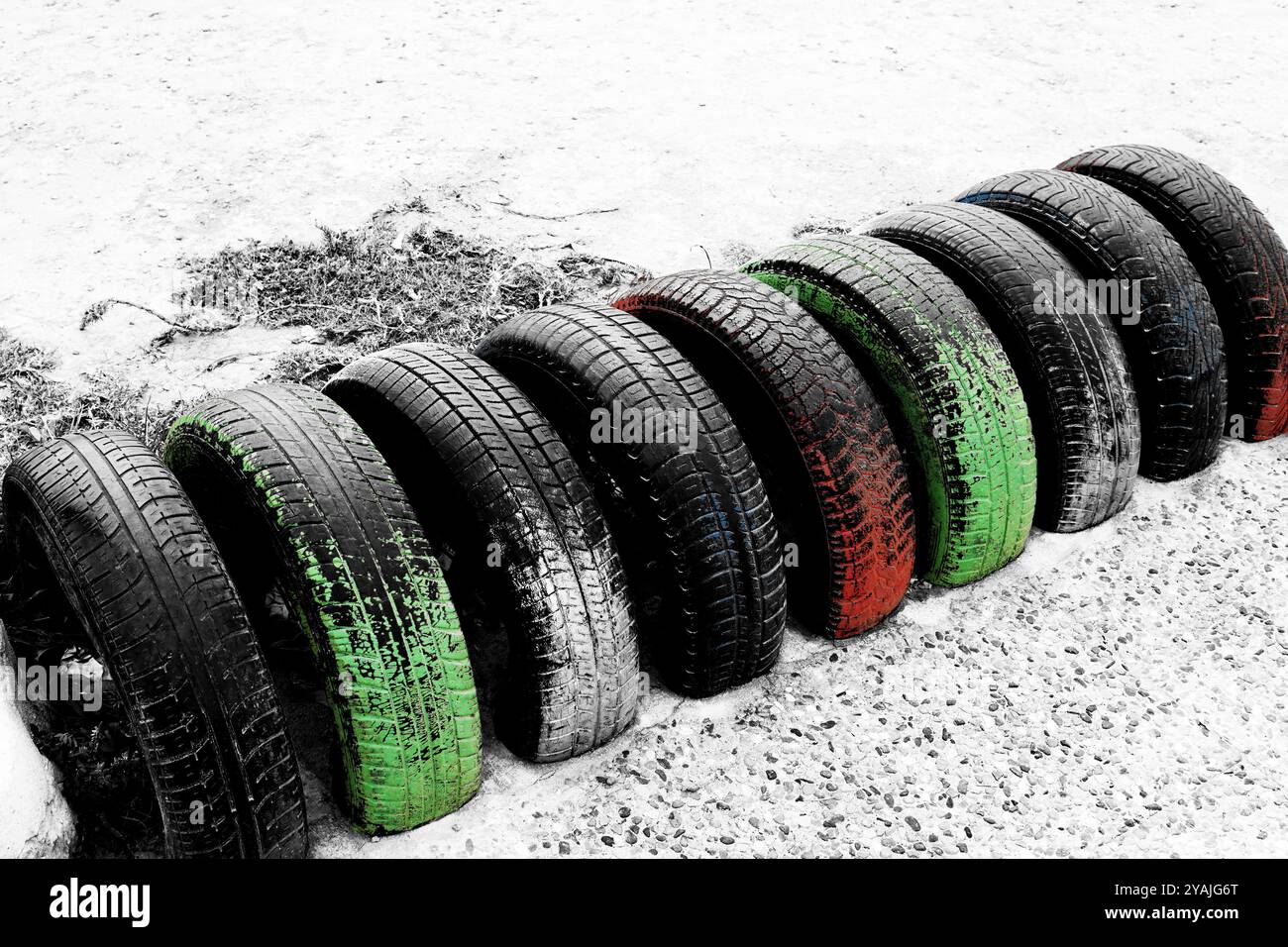 Row of painted used tyres with black and white background Stock Photo ...