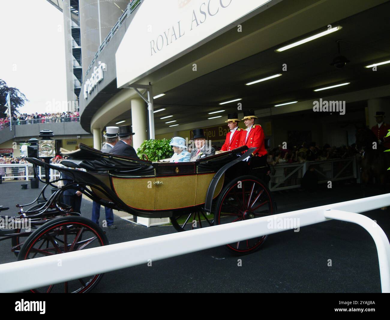 A smilling Prince Philip with Queen Elizabeth ii riding a carriage into ...