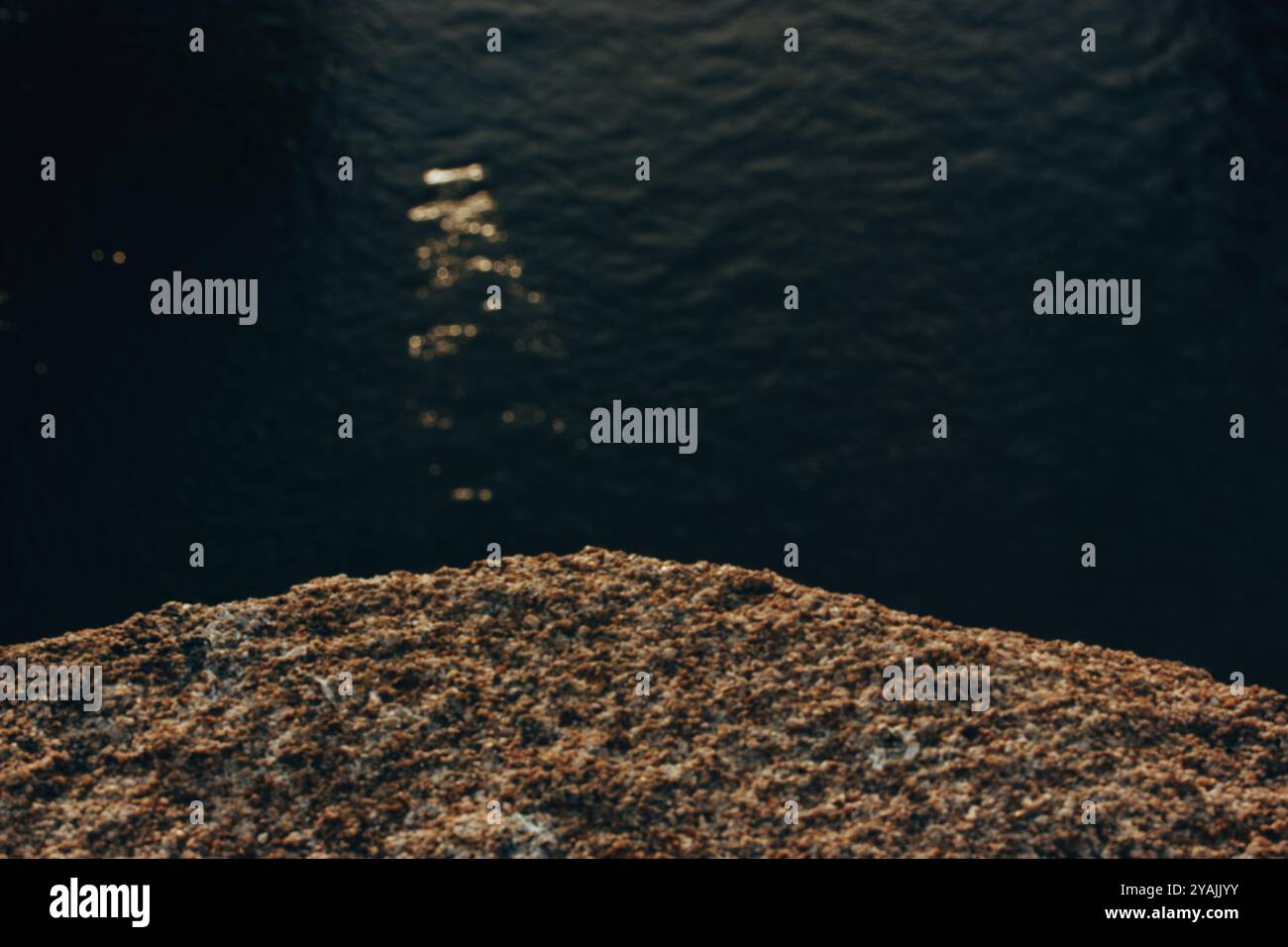 Rock podium. Seashore and stone parapet texture. Dark water in a sea, ocean aerial view ...