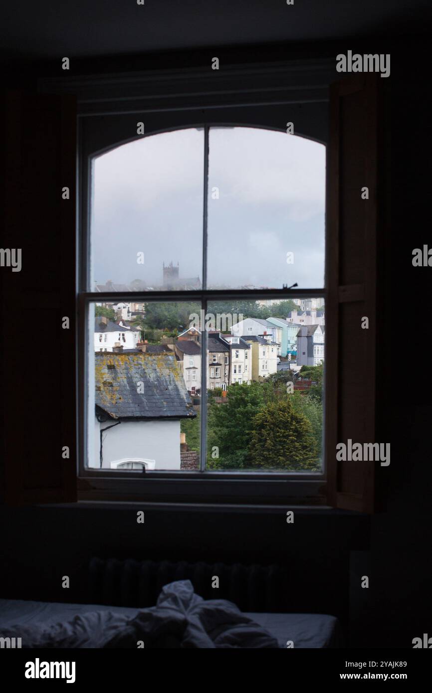 View through the window to rows of Victorian houses in England. Inside ...