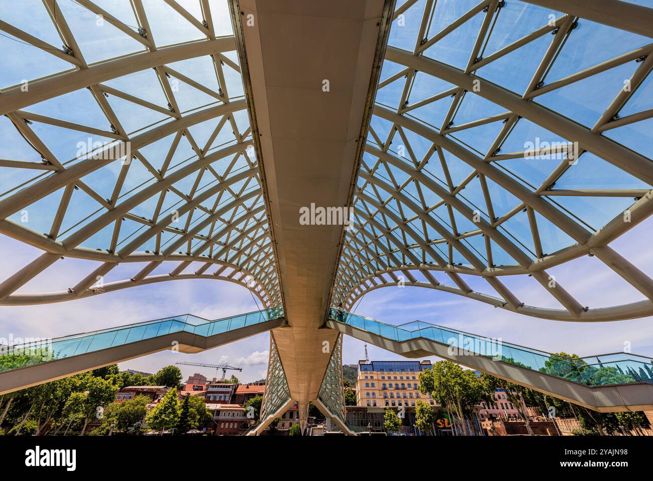 looking up at the glass canopy and pedestrian walkway and stairways of ...