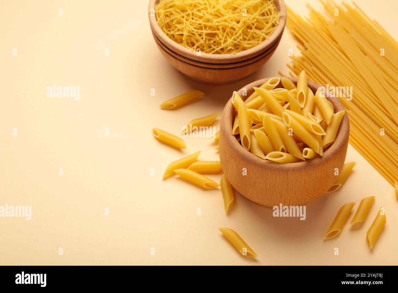 Various types of Italian pasta on beige background. Top view Stock ...