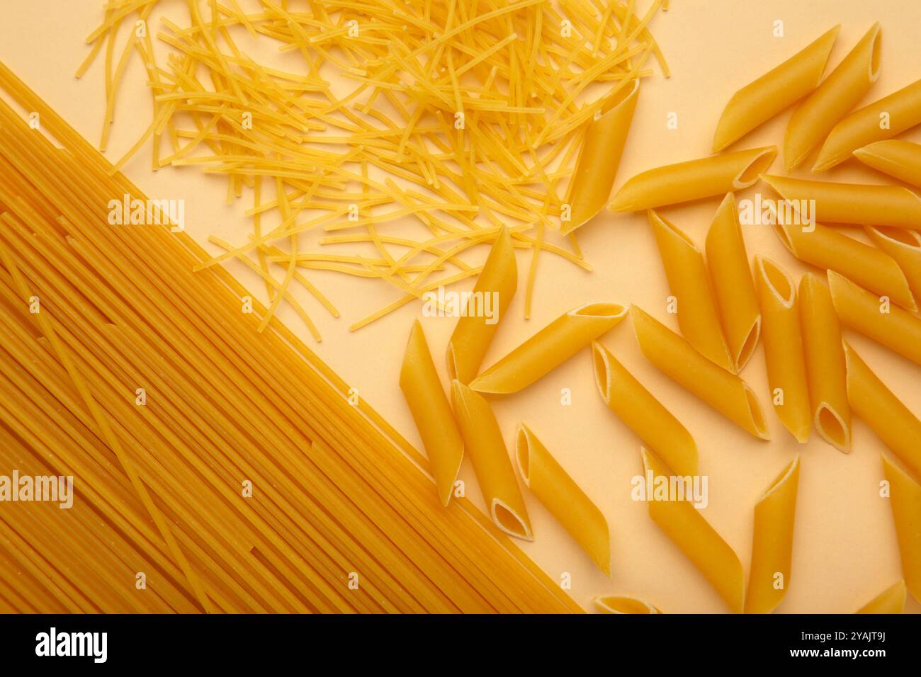 Assorted types of pasta on beige background. Various forms of pasta ...