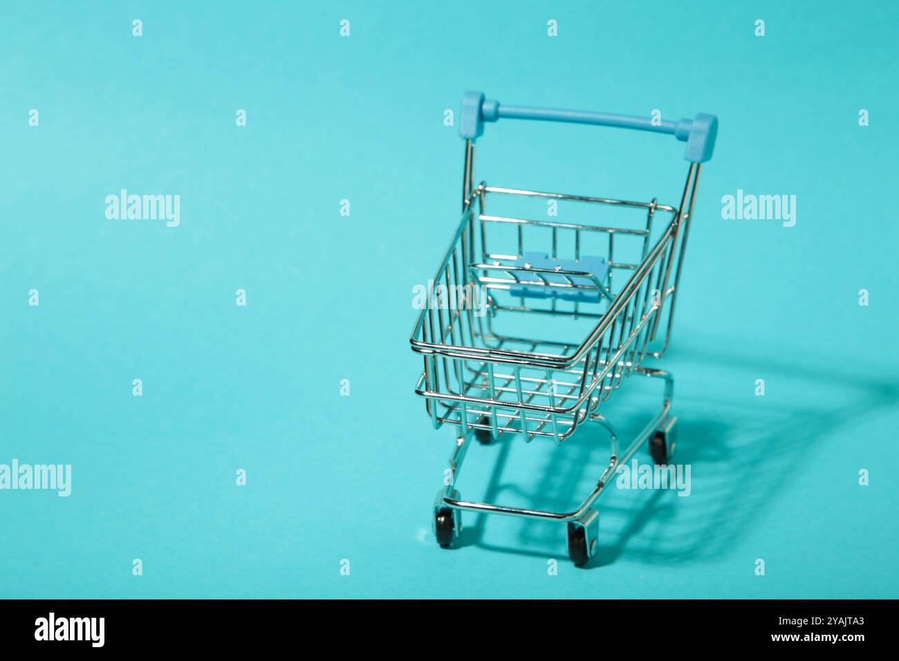 Shopping trolley on blue hi-res stock photography and images - Alamy