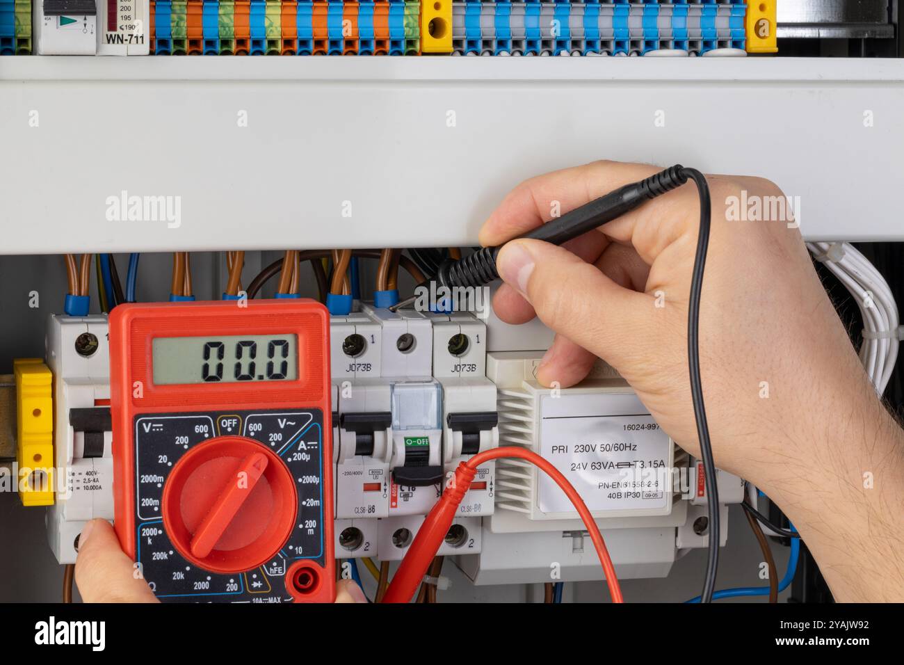 Electrician Measuring Voltage with Multimeter in Control Panel Stock ...