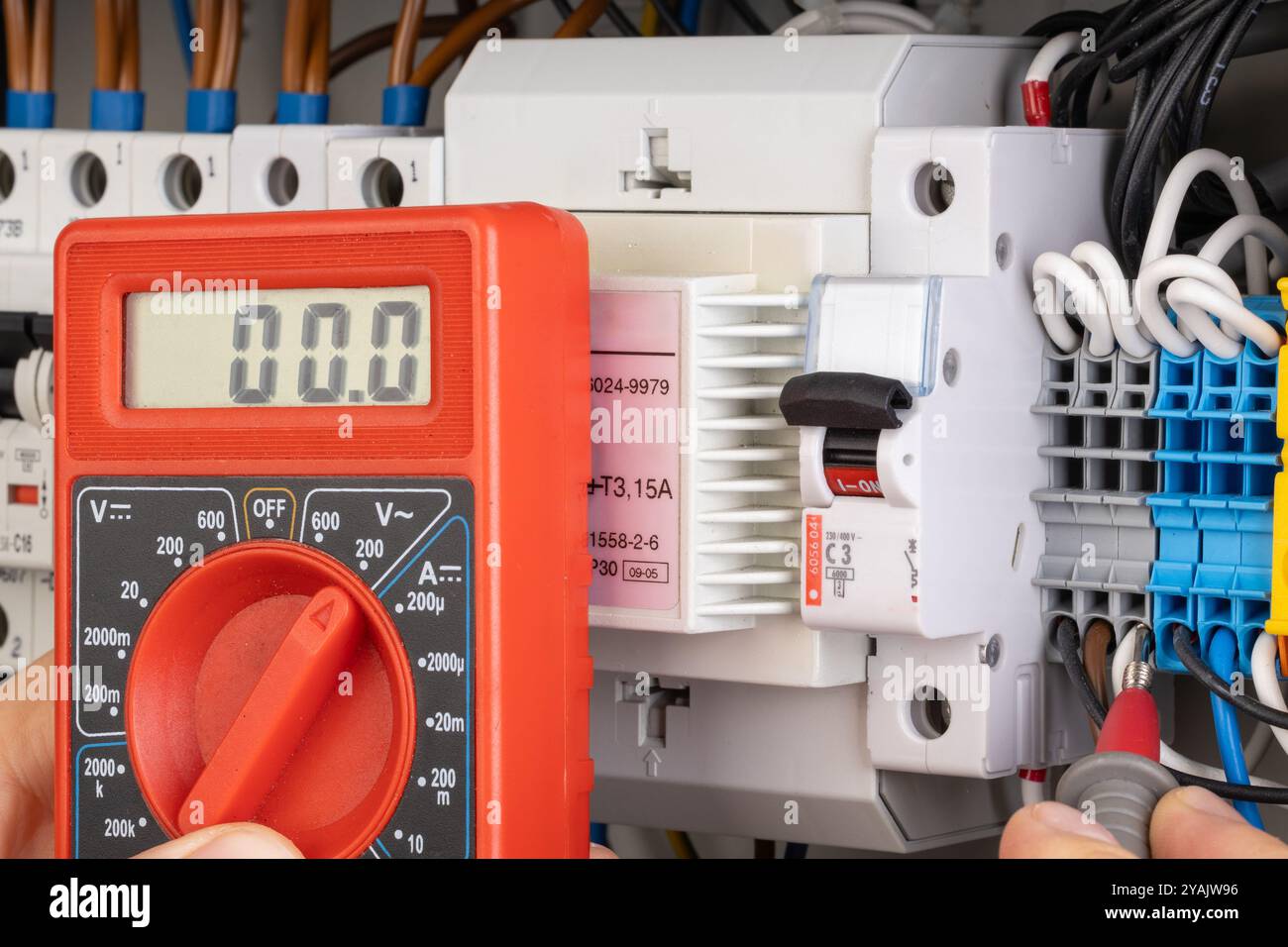 Electrician Testing Voltage with Multimeter in Panel Stock Photo - Alamy