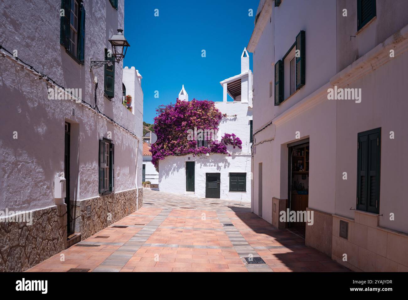 Traditional alley in spanish small town on a sunny summer day with ...