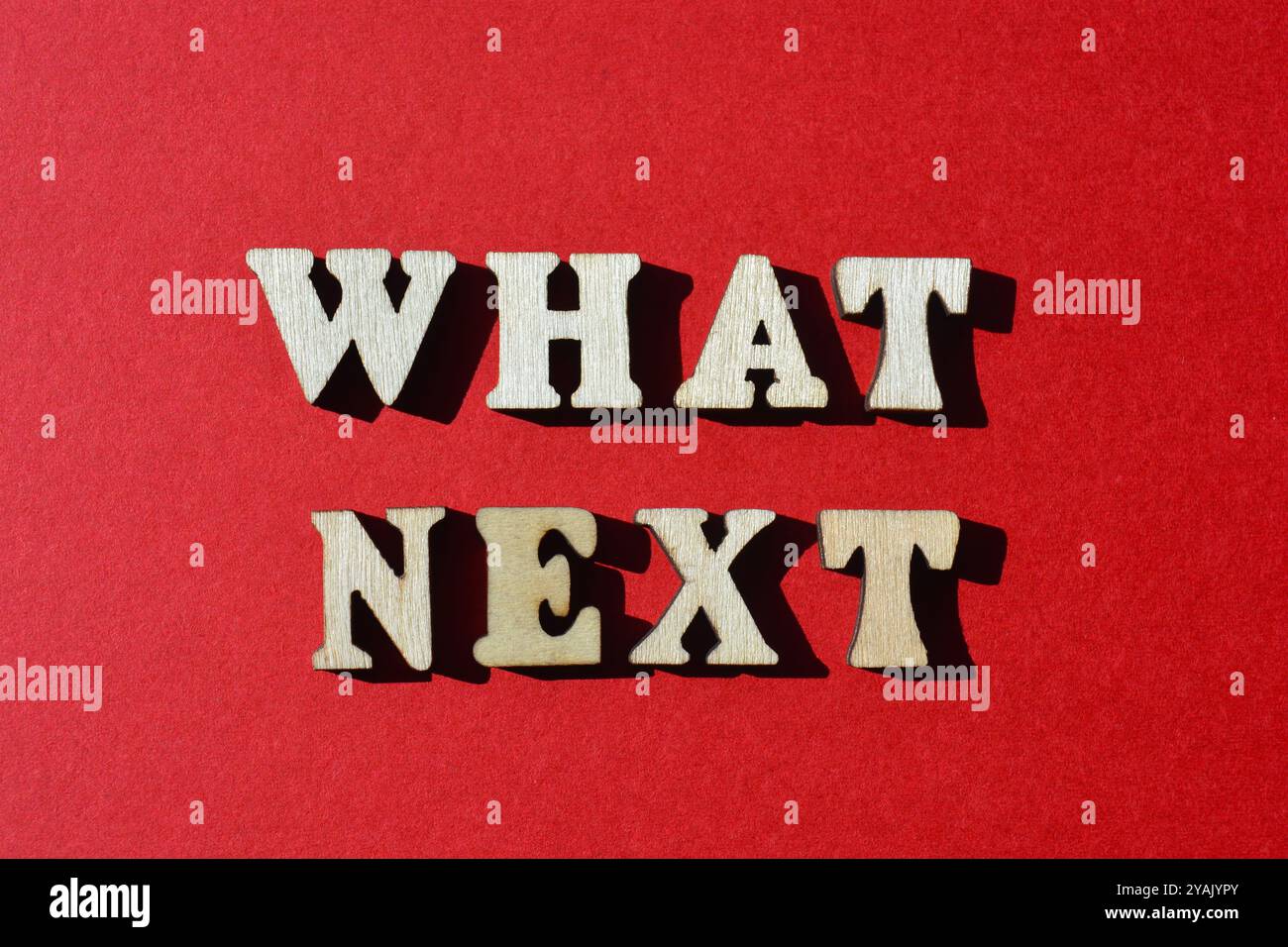 What Next, words in wooden alphabet letters isolated on red background ...