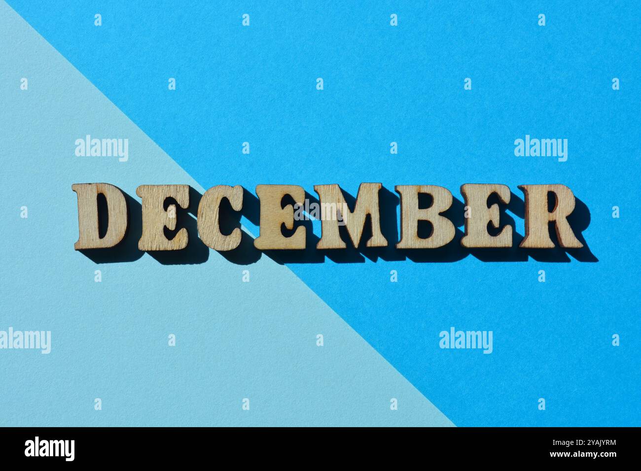 December, word in wooden alphabet letters isolated on blue background ...
