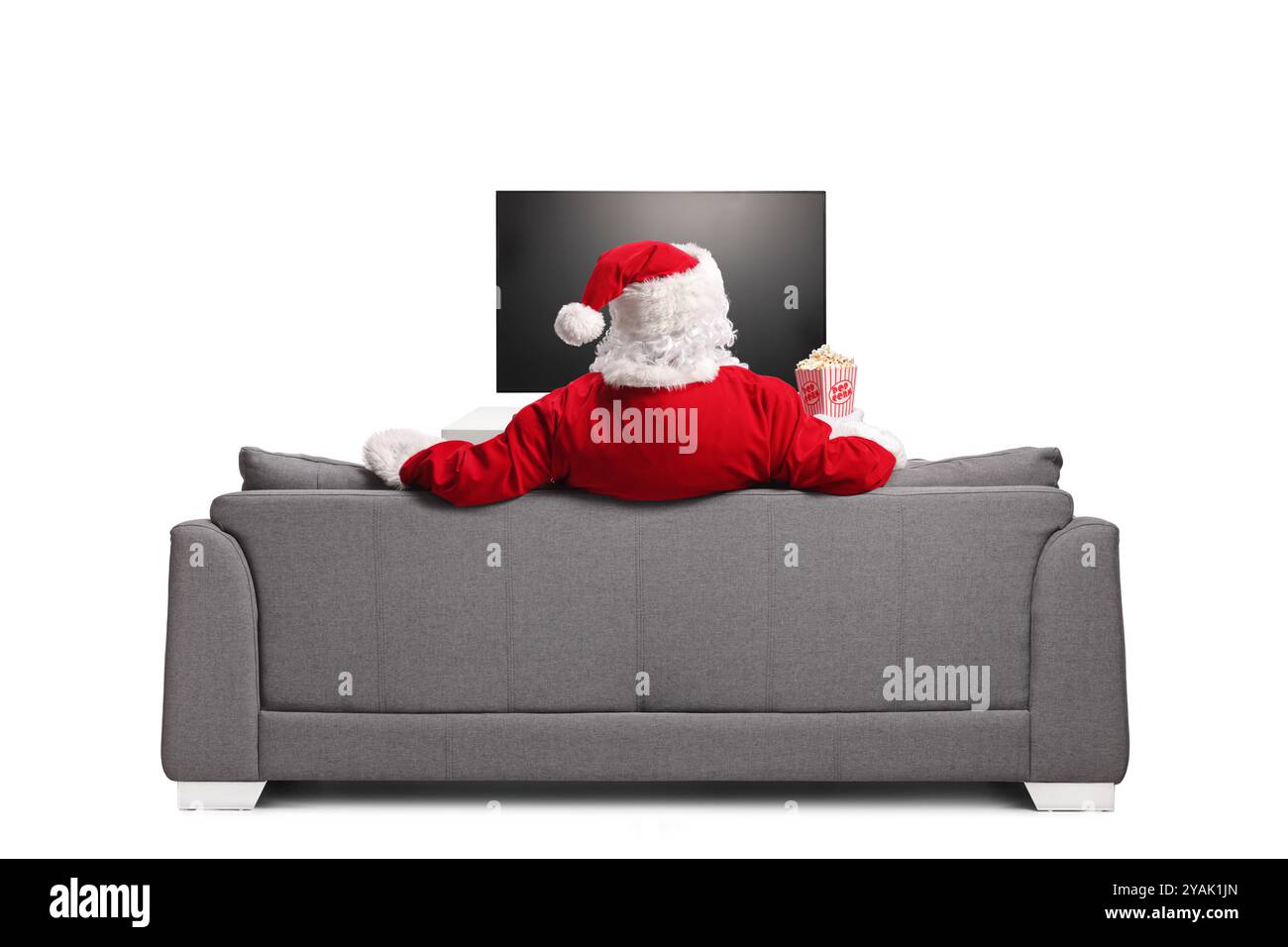 Santa claus sitting on a sofa and watching tv with a box of popcorn ...