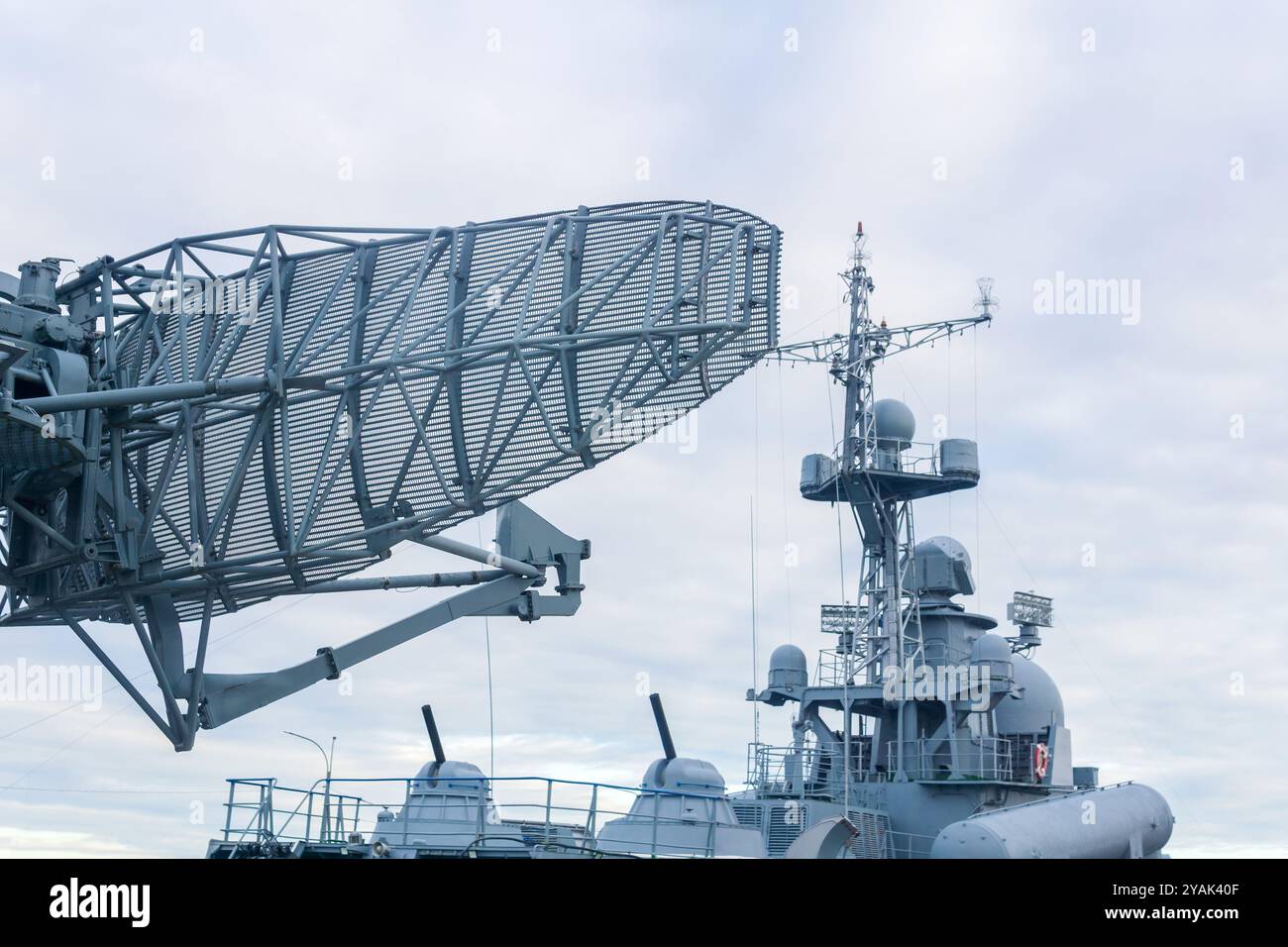 military background, naval radar antenna close up and warship in the ...