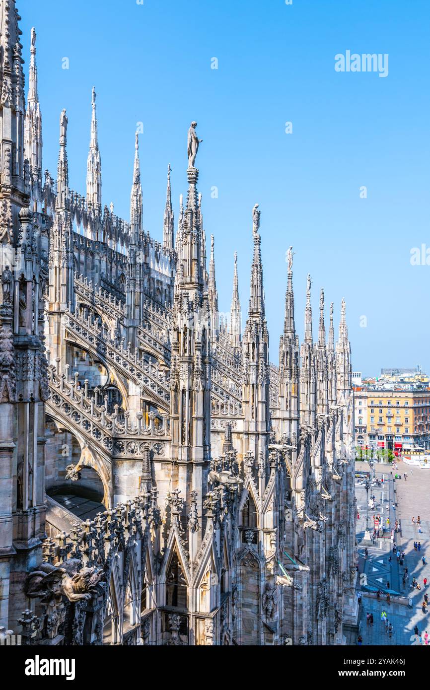 Visitors enjoy sweeping views of Milan from the rooftop of the Duomo ...