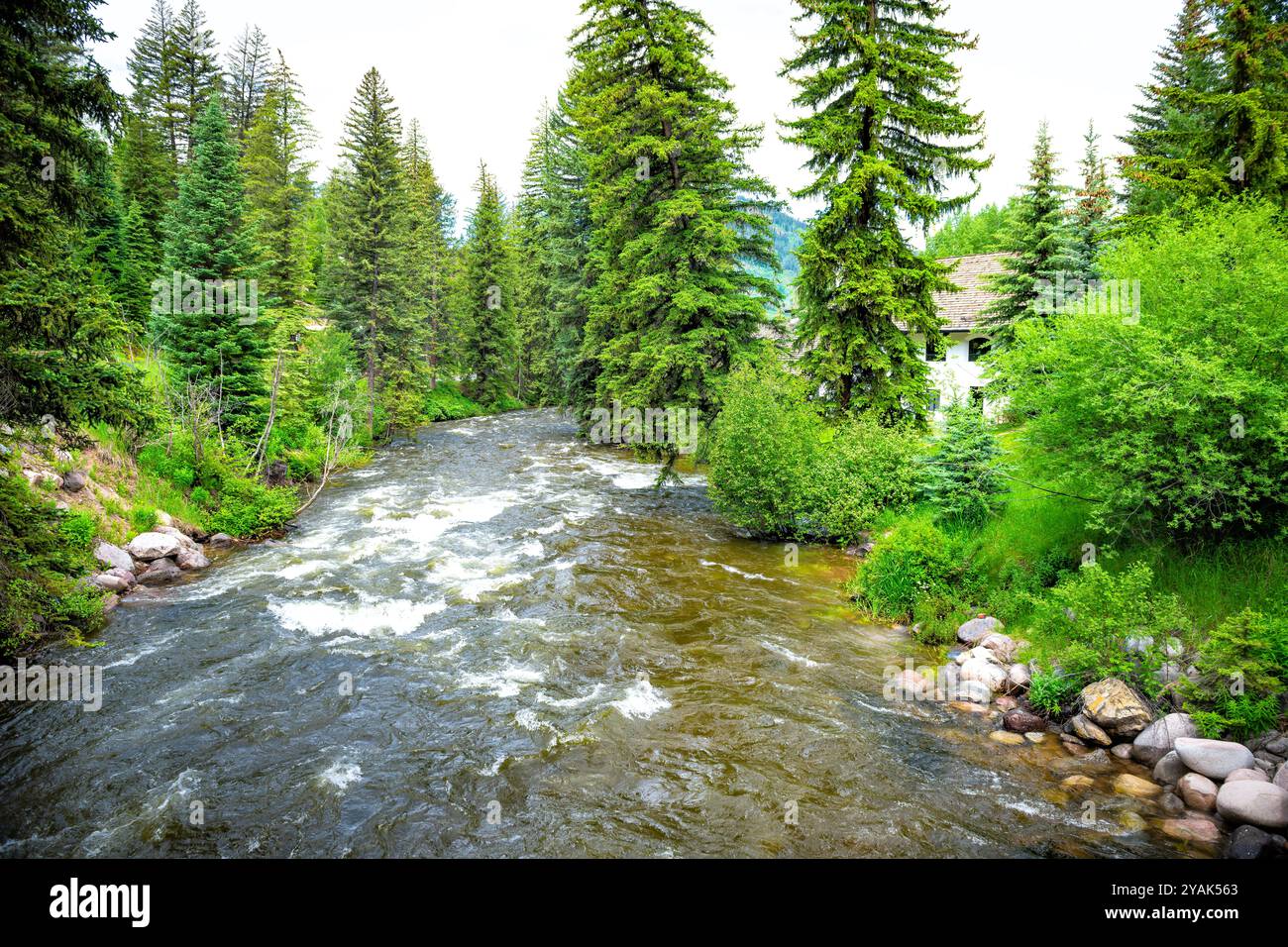 Vail, Colorado ski resort town with Gore creek river by lodge building ...
