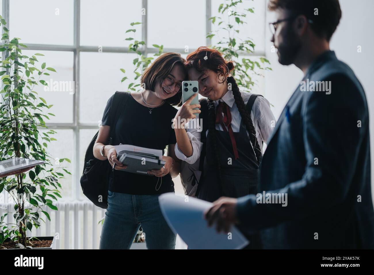 Students engaging with professor in bright study space Stock Photo - Alamy